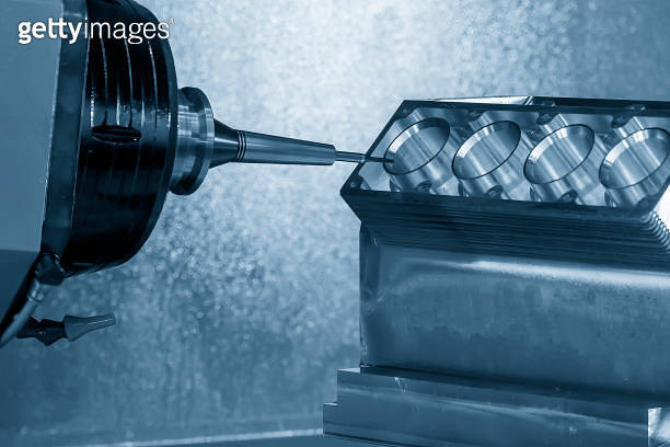 The 5-axis machining center cutting the V8 engine cylinder block with ...