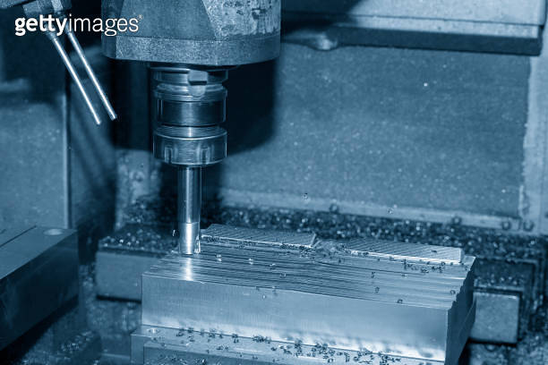 The CNC milling machine rough cutting the injection mold parts by ...