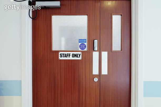 Staff Only double doors with coded key entry seen in a corridor of an ...