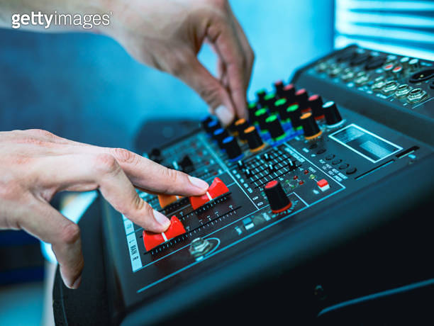 Sound engineer hands adjusting control sound mixer in recording ...