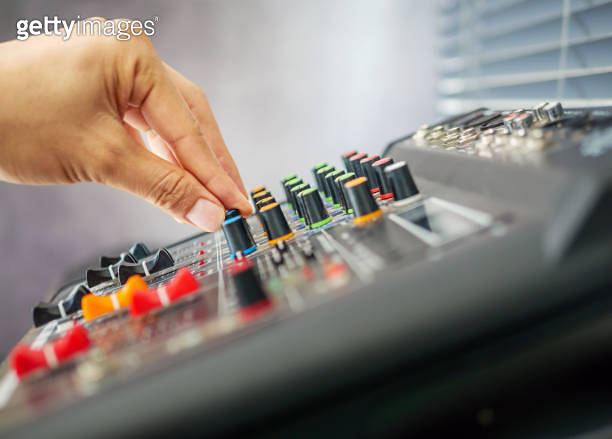 Sound engineer hands adjusting control sound mixer in recording ...
