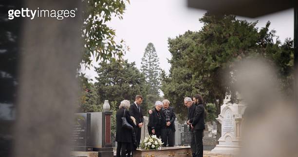 People at a funeral, death and graveyard with family mourning outdoor ...