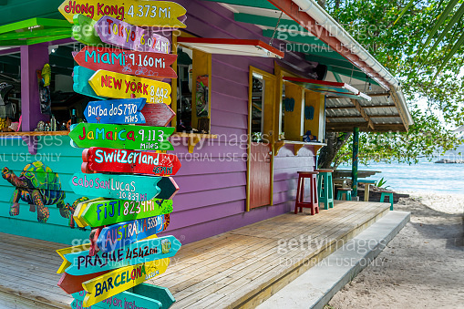 Colorful wooden travel direction signs, bear bar in La DIgue island ...
