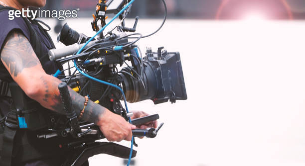 Blurred images of high definition video camera and lens on steady ...