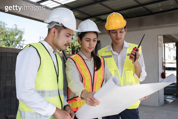 team of civil engineers and architects wearing hard hats Currently in a ...