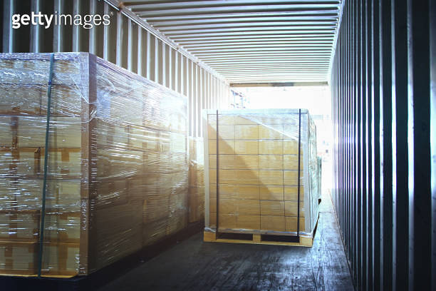 Pallets of goods loaded into containers. Delivery of parcel boxes to ...