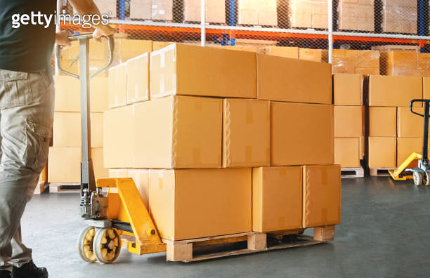 Workers Loading a Package Boxes in Warehouse. Cartons, Cardboard Boxes ...