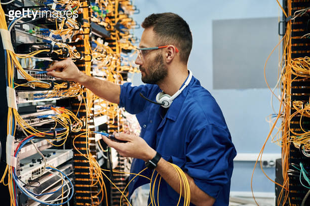 Modern technology routing. Young man is working with internet equipment ...