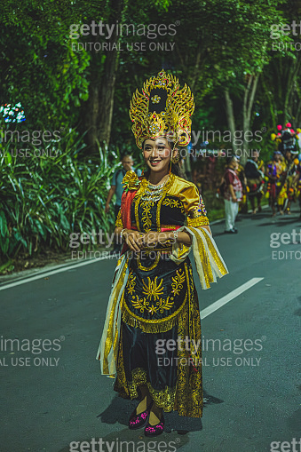A young pretty girl wearing a crown and cosplay influenced by East Java ...
