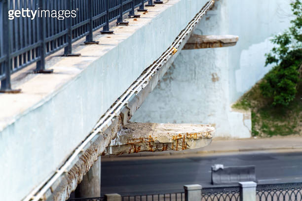 Dramatic image of collapsing concrete pillars of a car bridge over a ...