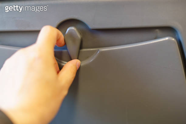 Human hand engaging the latch of a foldable train table, preparing for ...