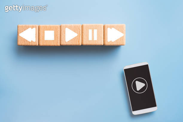 mobile phone with play sign on touchscreen, and audio , video playing ...