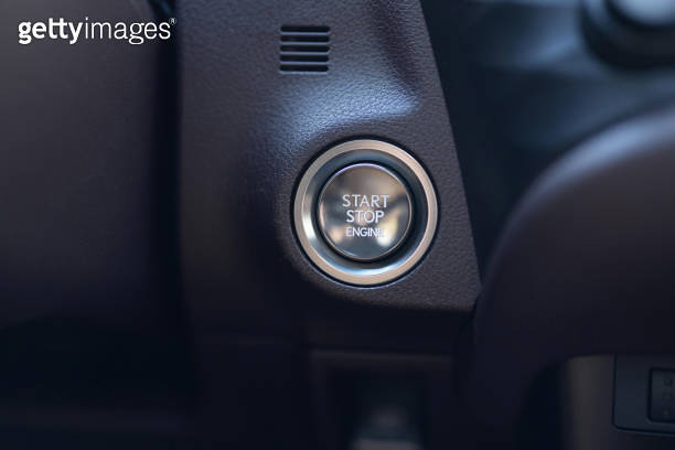 Starting car engine. Button to start the car engine. Pushing start stop ...