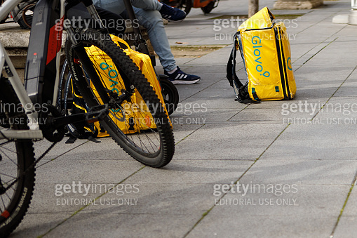 Detail of a Glovo delivery backpack while the delivery man waits for ...