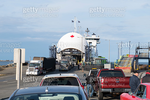 Semi-trucks exiting a ferry boat at the Caribou Ferry Terminal in Nova ...