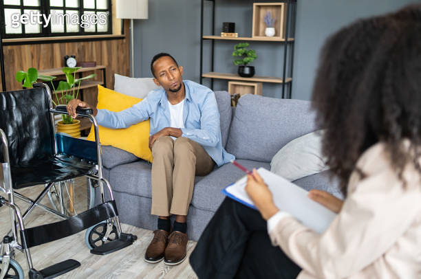 Psychologist listening to a disabled patient at psychotherapy session ...