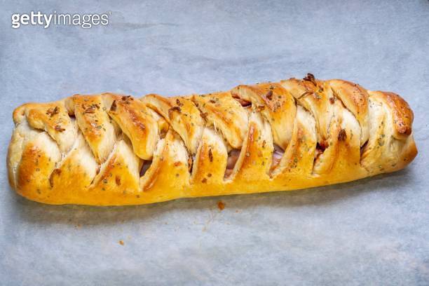 Pizza braid. Delicious braided pizza bread stuffed with cheese, bacon, ham and tomato or ...