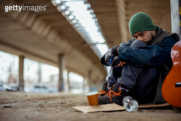 Homeless Man Looking at Camera While Sitting Under the Bridge 이미지 ...