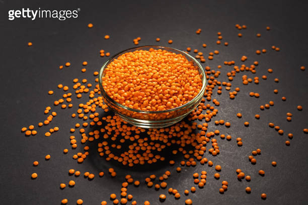 Red lentils in glass bowl. Dry orange lentil grains, heap of dal, raw ...