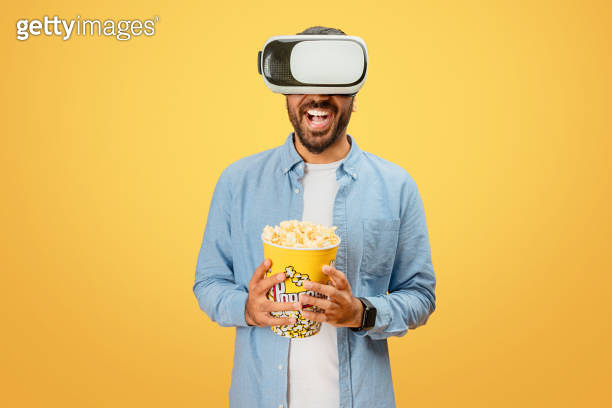 VR user with popcorn delighted by virtual world (2153437894) - 게티이미지뱅크