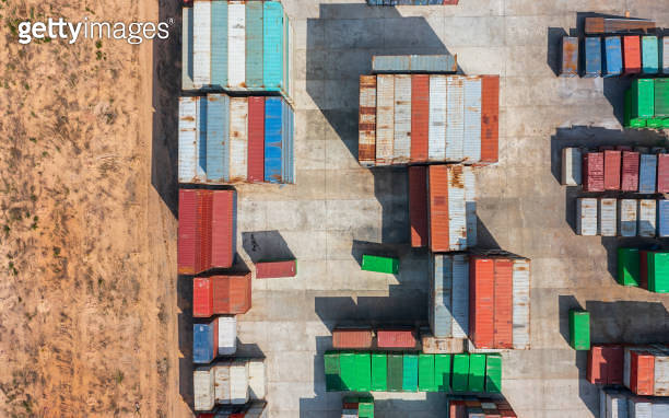 Stack of cargo containers in a terminal shipping yard, aerial top view ...