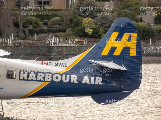 The tail of a Harbour Air seaplane, featuring its distinctive blue and ...