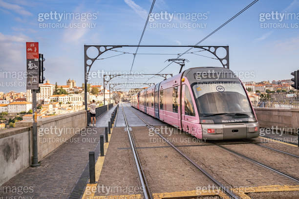 Porto Metro train runs along the Ponto do Freixo Bridge in Porto ...