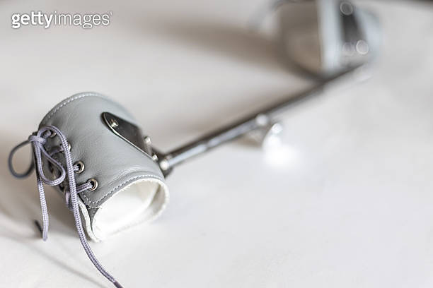 Close-up of an orthopedic brace, specifically a Wilensky splint, used ...