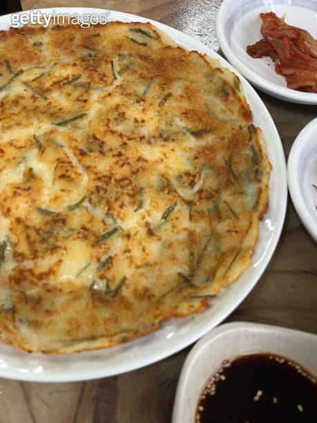Golden-brown gamja jeon, a classic Korean potato pancake, crispy on the ...