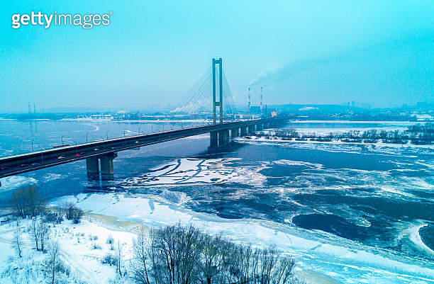 Kyiv city in an early winter morning. Drone view of frozen Dnieper ...