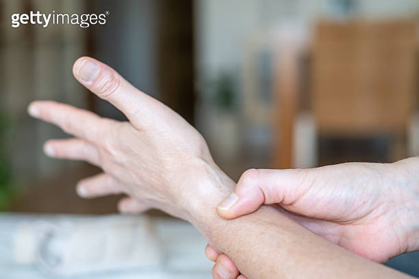Woman suffering from wrist pain caused by rhizarthrosis, a degenerative ...